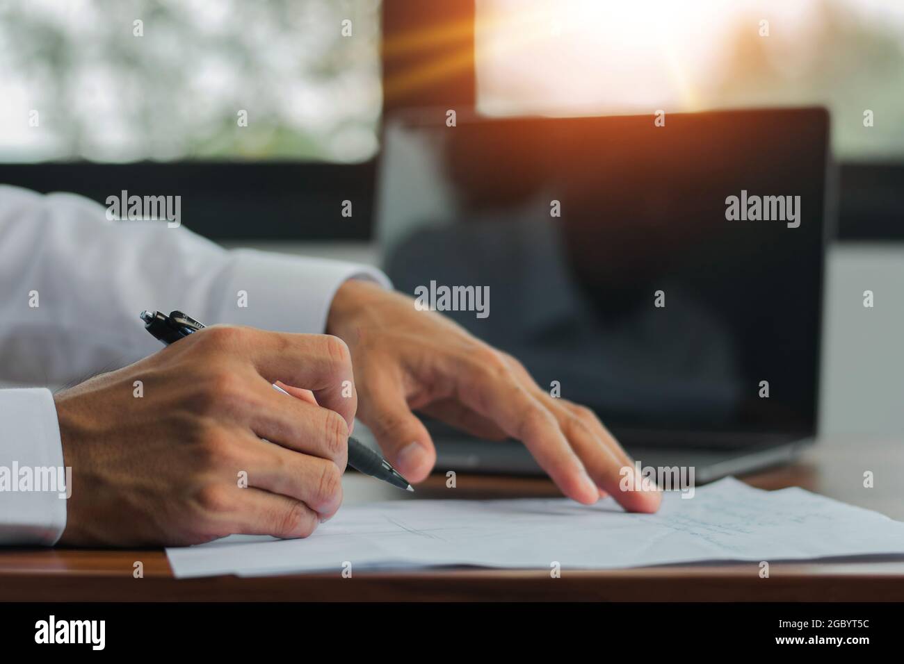 Side view hand writing pen on document computer background, Closeup ...