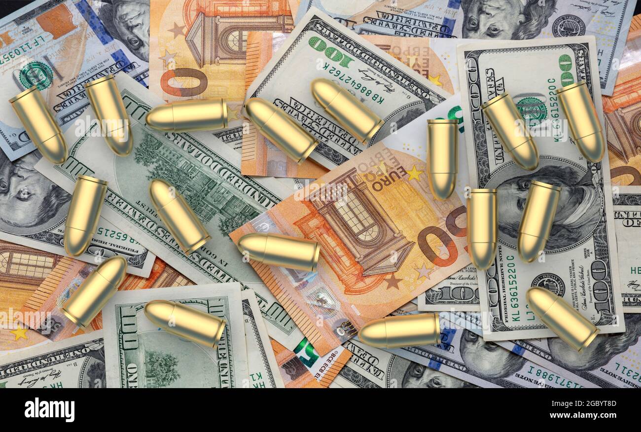 Criminal money. Pistol bullets on dollar and euro banknotes background ...