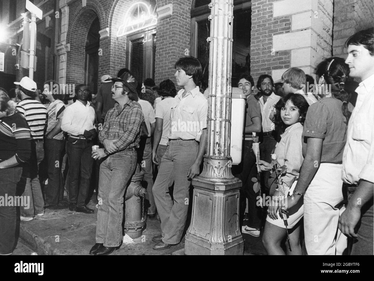 Austin Texas USA, circa 1984: Crowds of young people clog the sidewalks ...