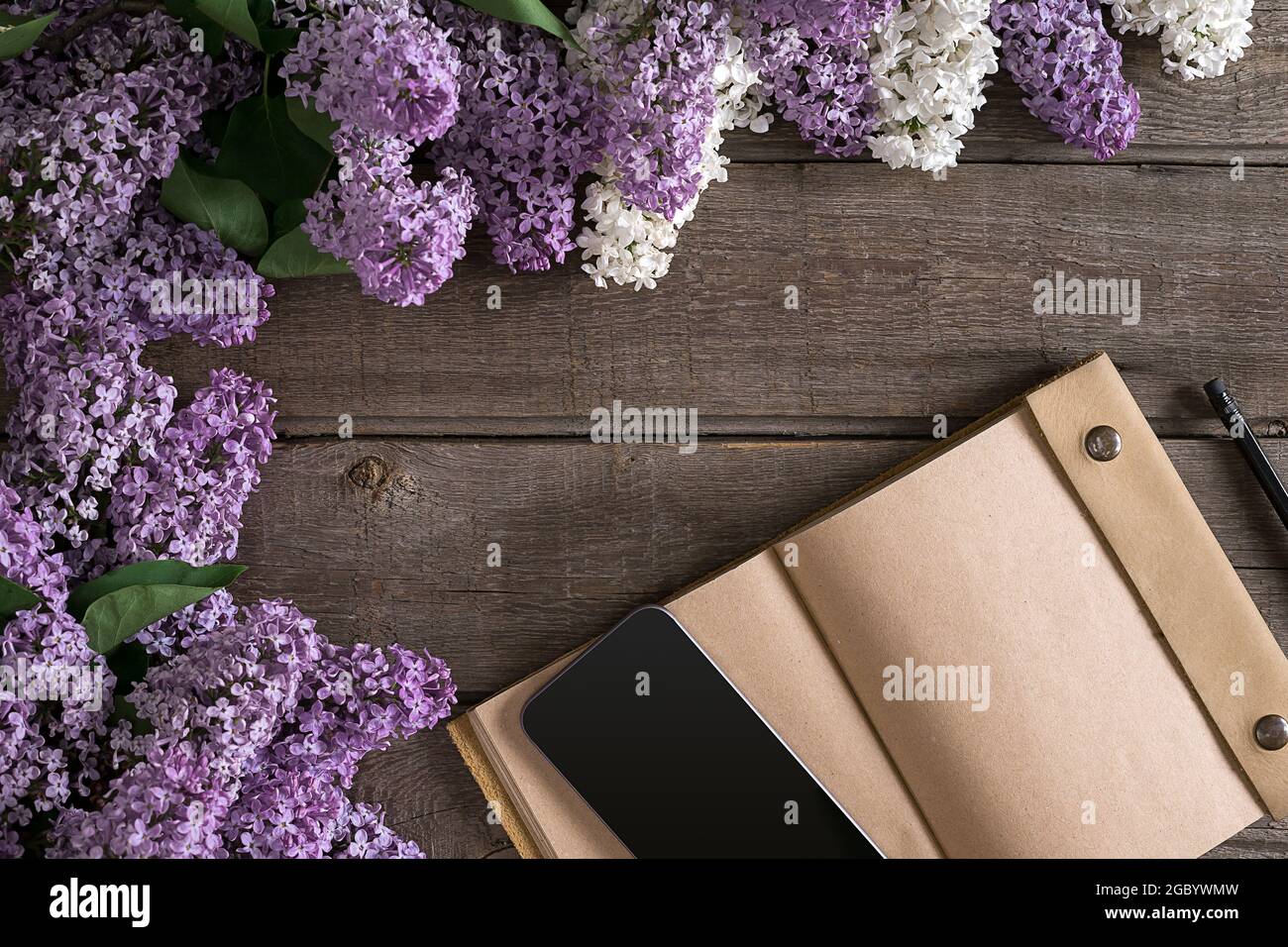 Lilac blossom on rustic wooden background with notebook for greeting ...