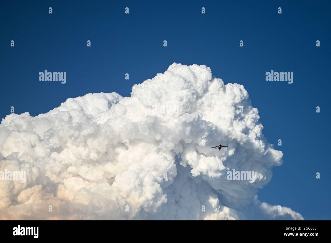 USA. 15th July, 2021. A firefighting aircraft silhouetted by the ...