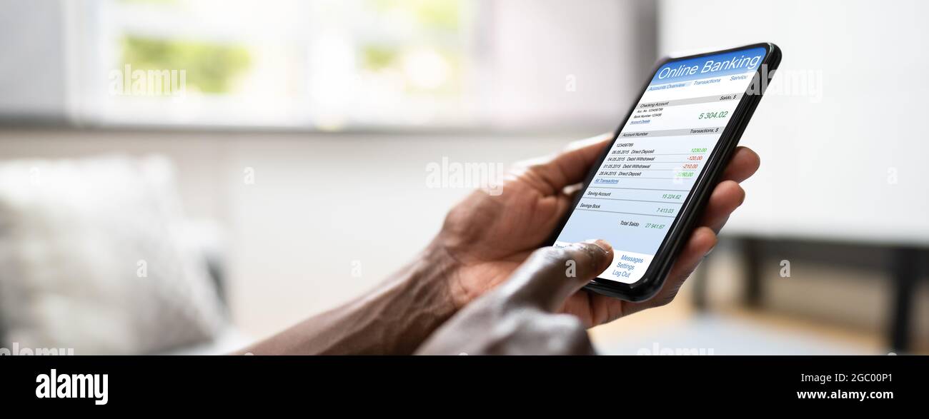 African American Using Online Banking On Mobile Phone Stock Photo - Alamy