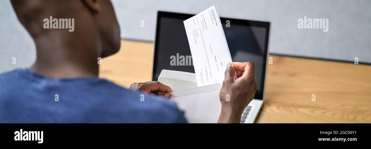 African Opening Payroll Cheque. Salary Payment Check Stock Photo - Alamy