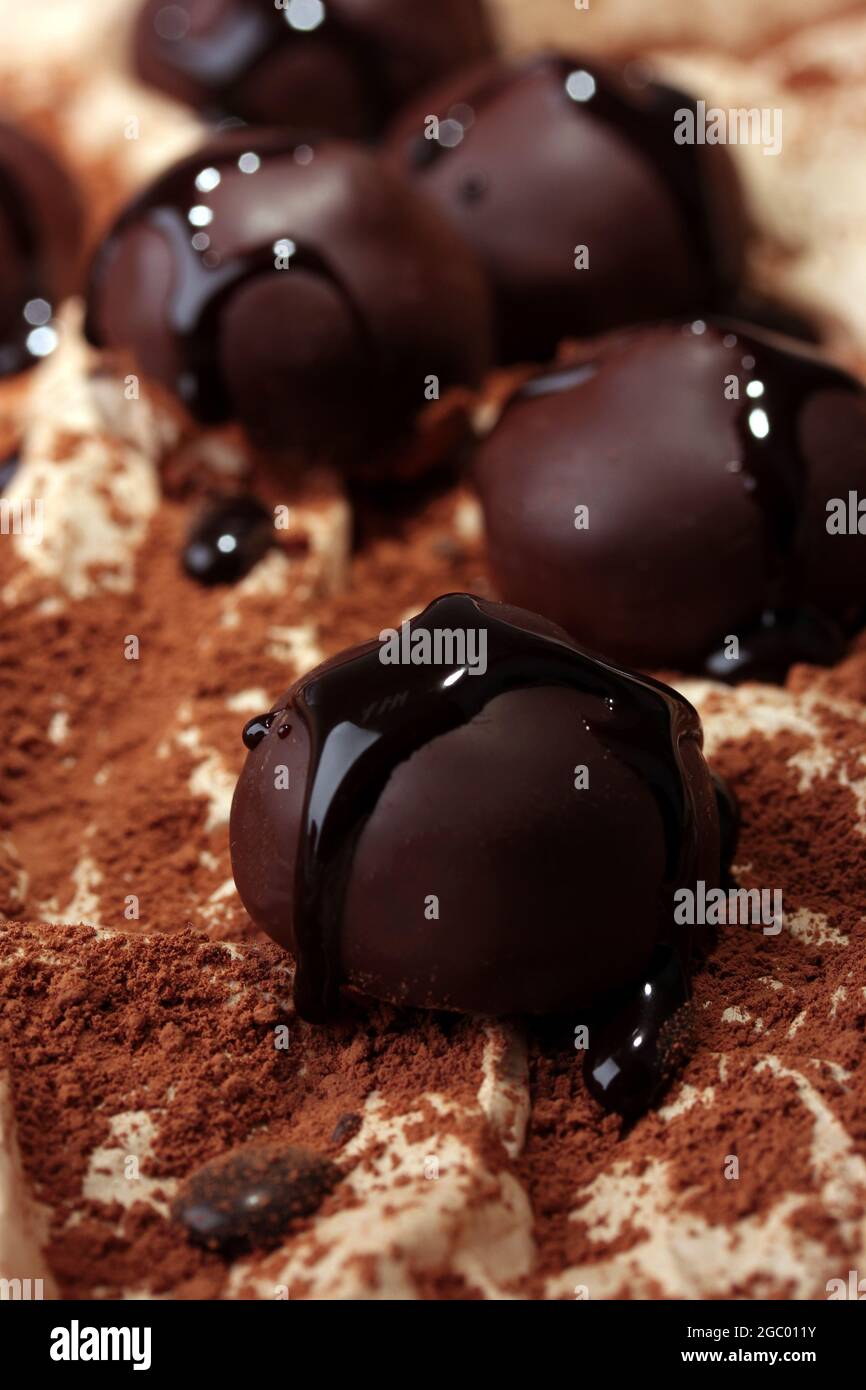 Chocolate candies with cocoa powder, close up Stock Photo - Alamy
