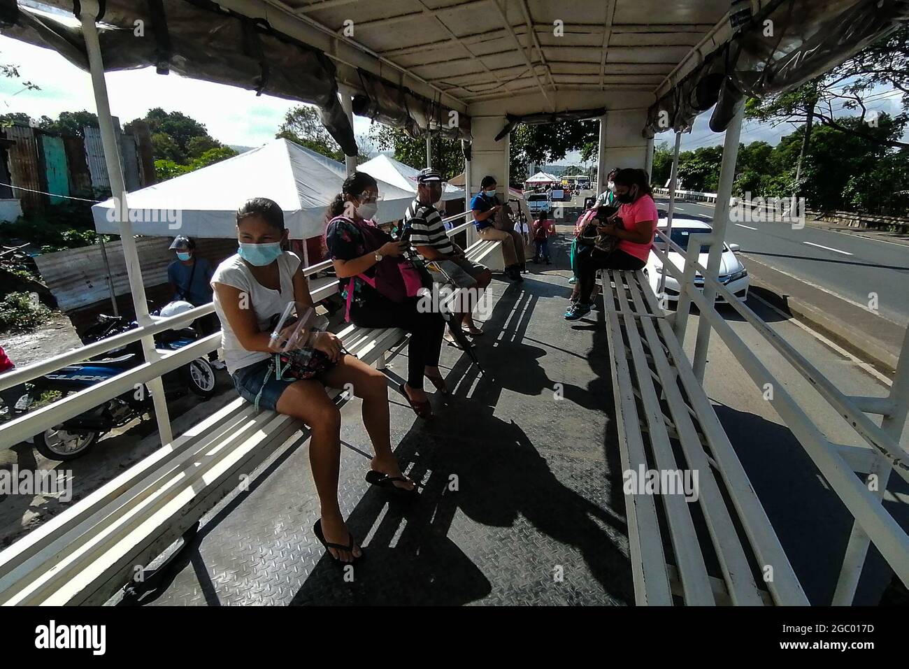 Stranded commuters take free rides provided by QCPD at a border between ...