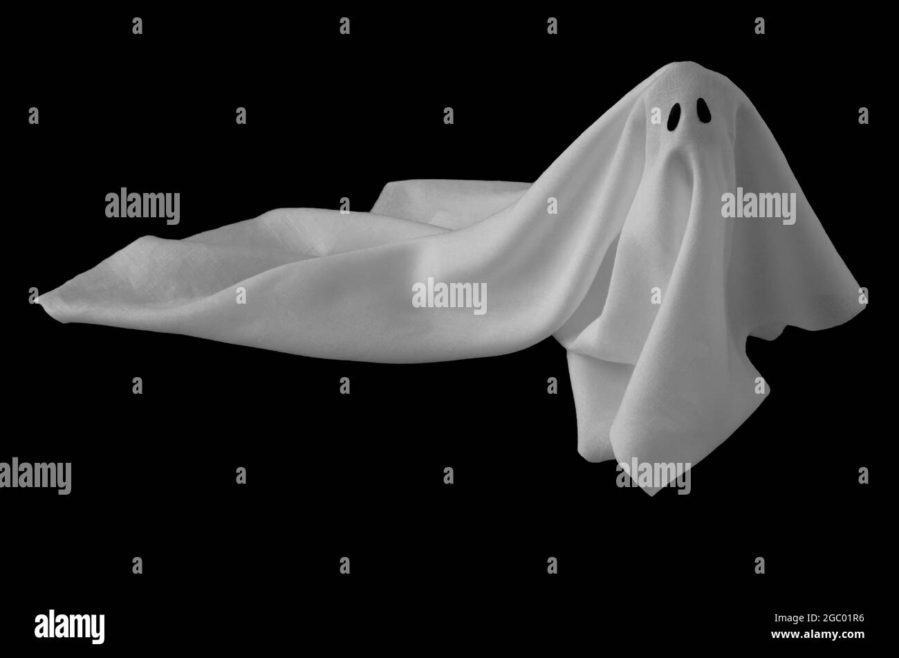 White ghost sheet costume rise up from the floor with black background ...