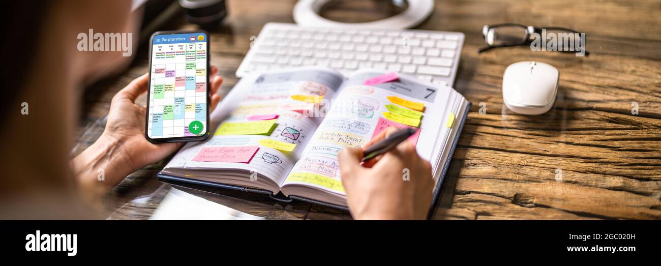 Calendar Schedule List At Desk And In Mobile Phone Stock Photo - Alamy