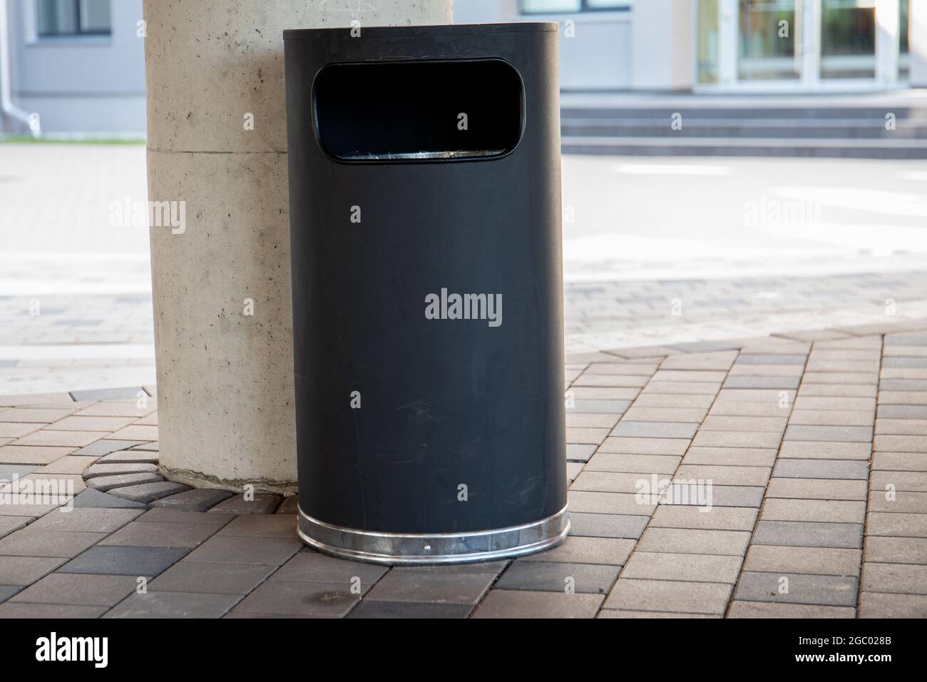 Modern rubbish bin on a street in a public place. Warm and sunny day ...