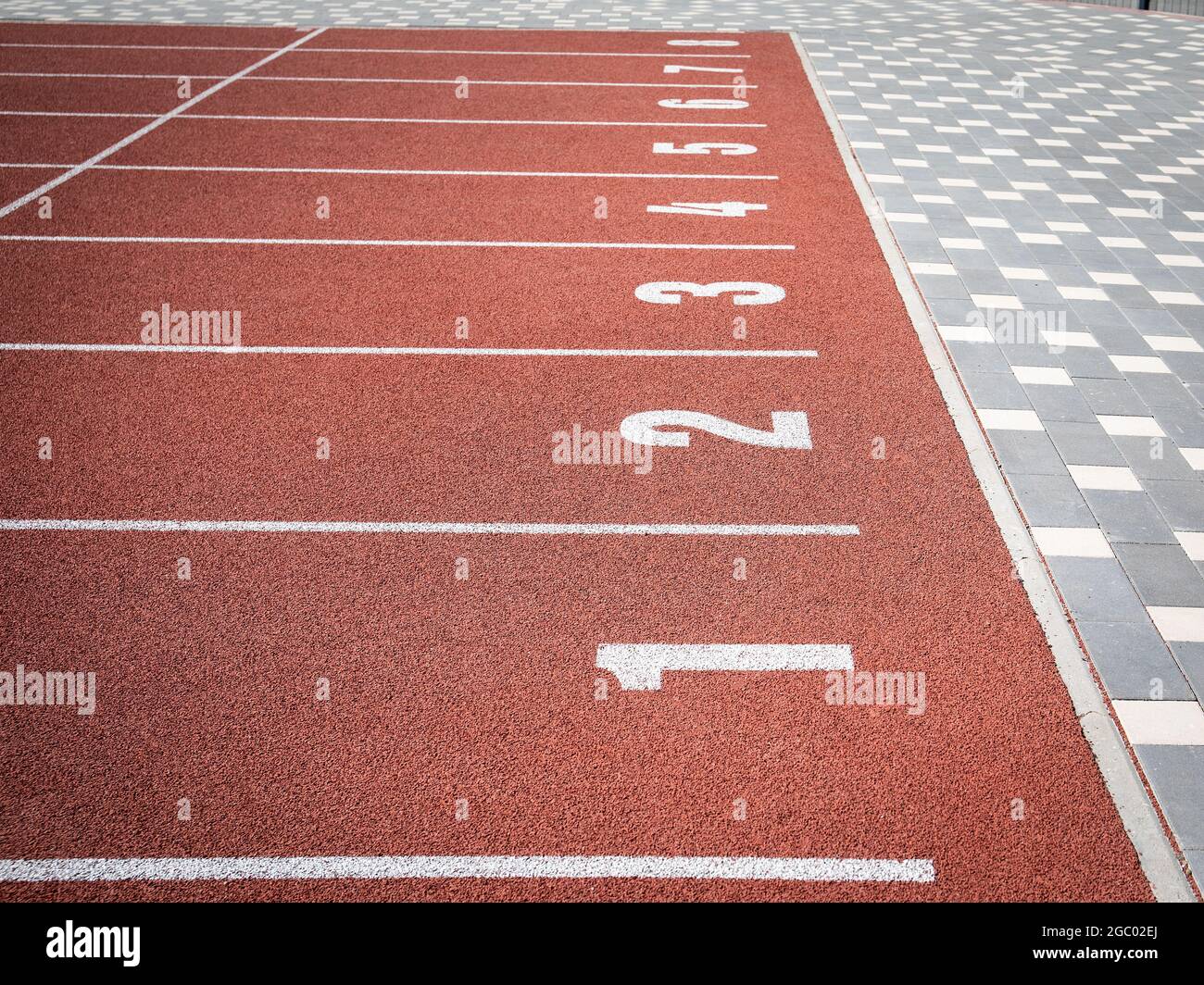 Starting position. Red running track in stadium Stock Photo - Alamy