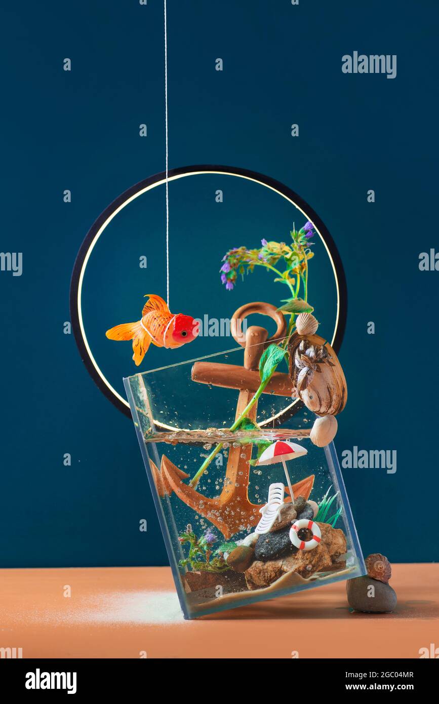 Fish tank with anchor, deck chair and umbrella, summer vacation concept ...