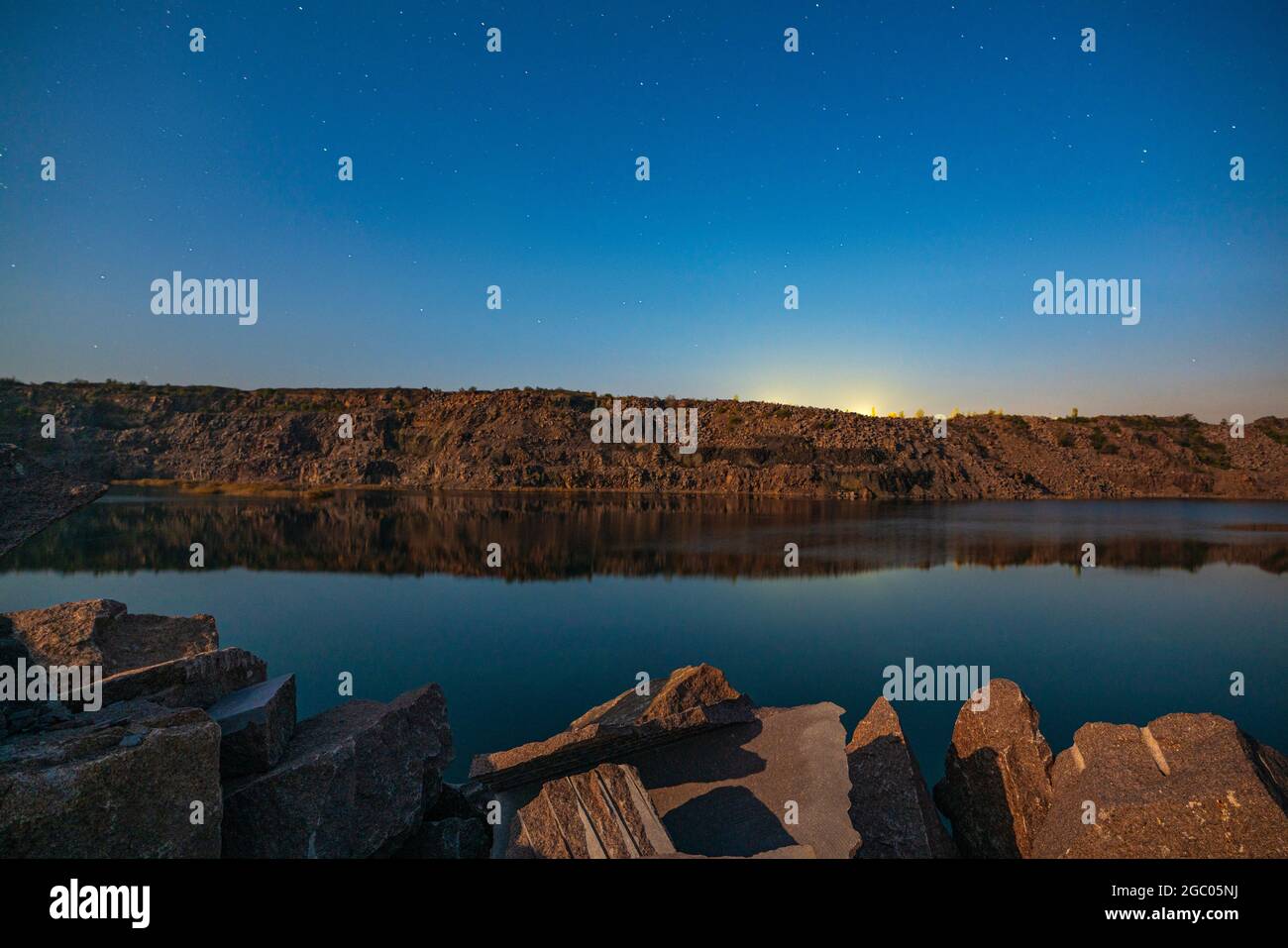 Small lake surrounded by stone waste from mine work Stock Photo - Alamy
