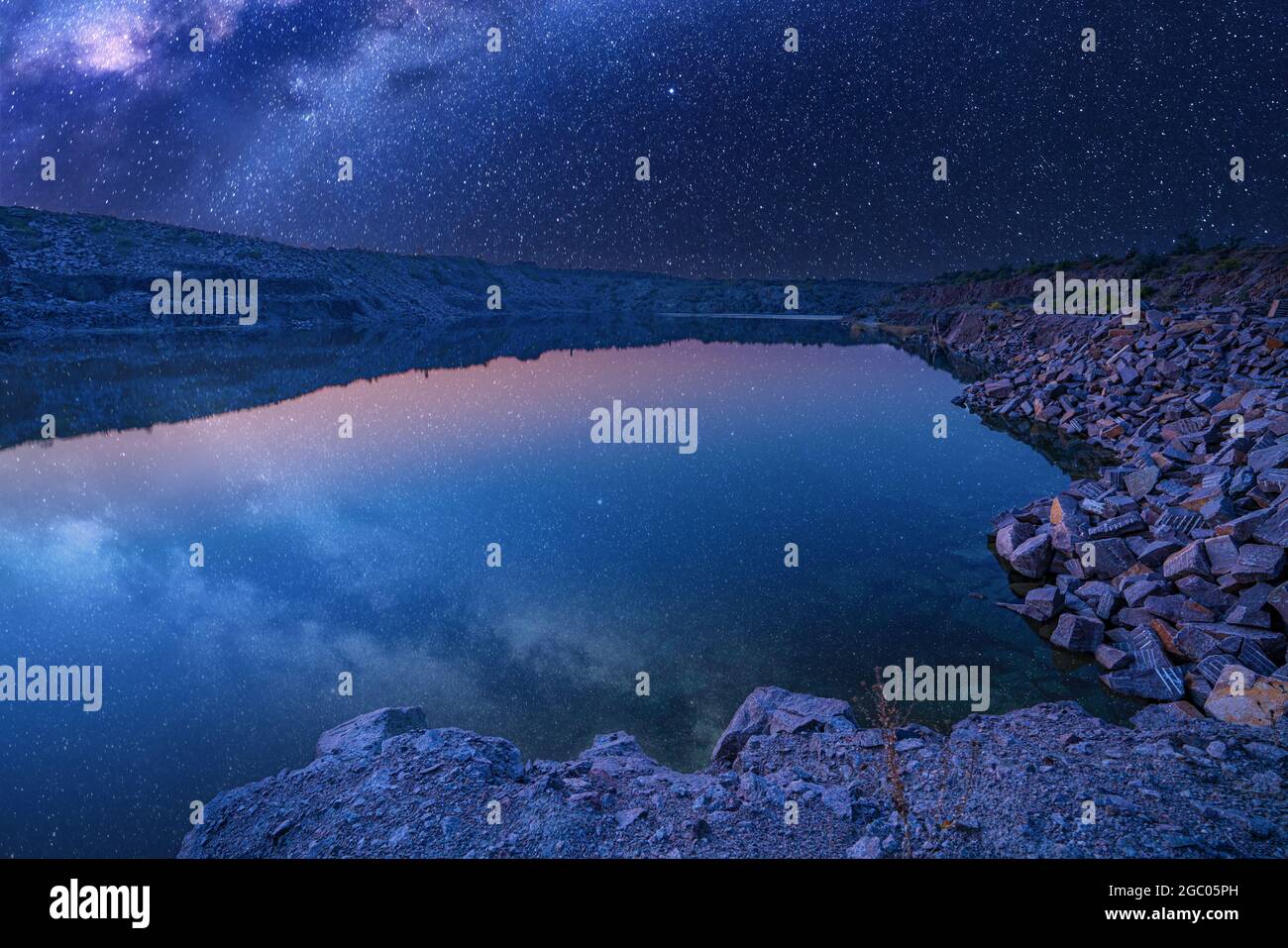 Small lake surrounded by stone waste from mine work Stock Photo - Alamy