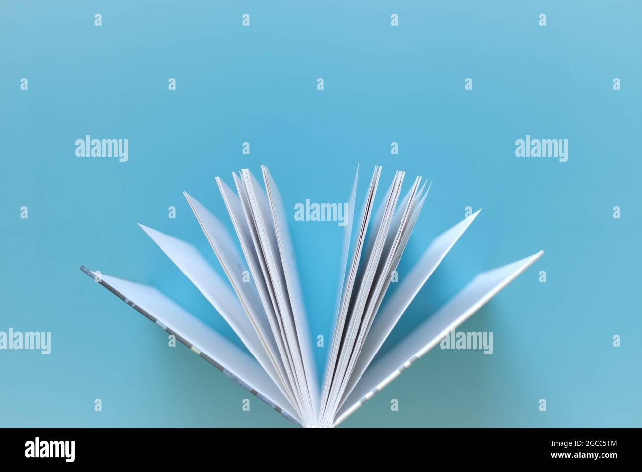 Book on a blue background.Reading and education concept. Knowledge and ...