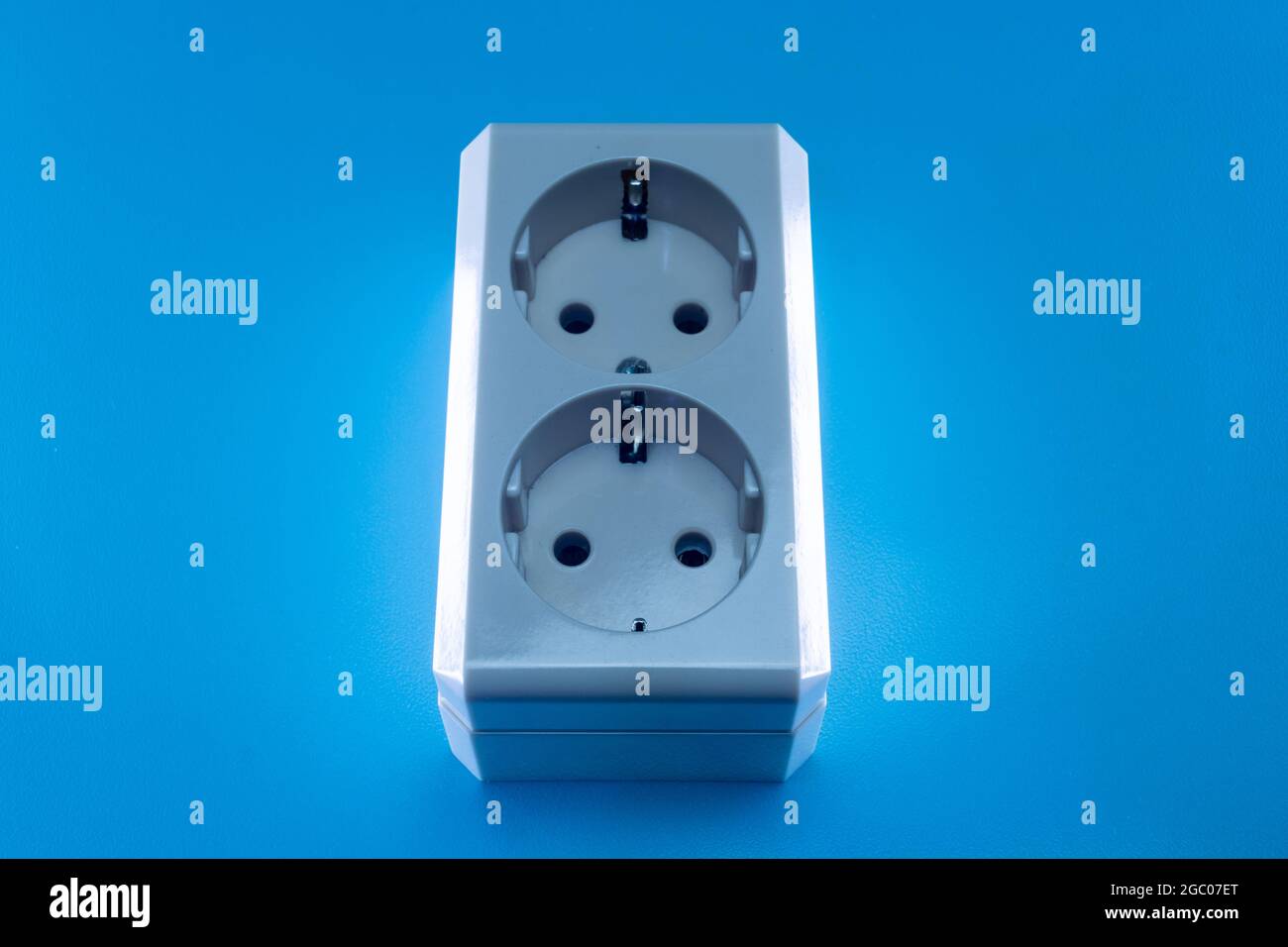 Electric double socket on a blue background Stock Photo - Alamy