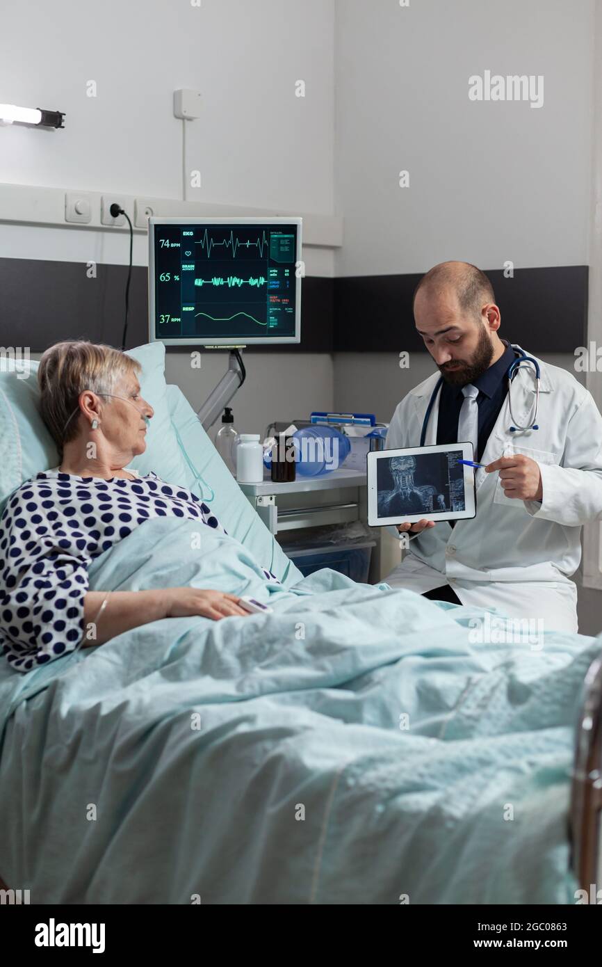 Sick senior woman receiving a medication through an intravenous line ...