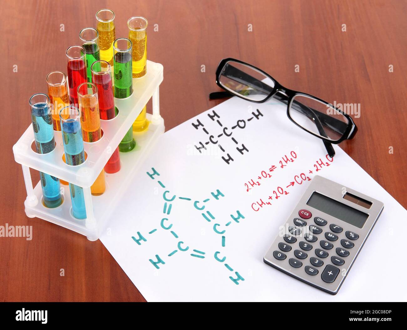 Test tubes with colorful liquids and formulas on table Stock Photo - Alamy