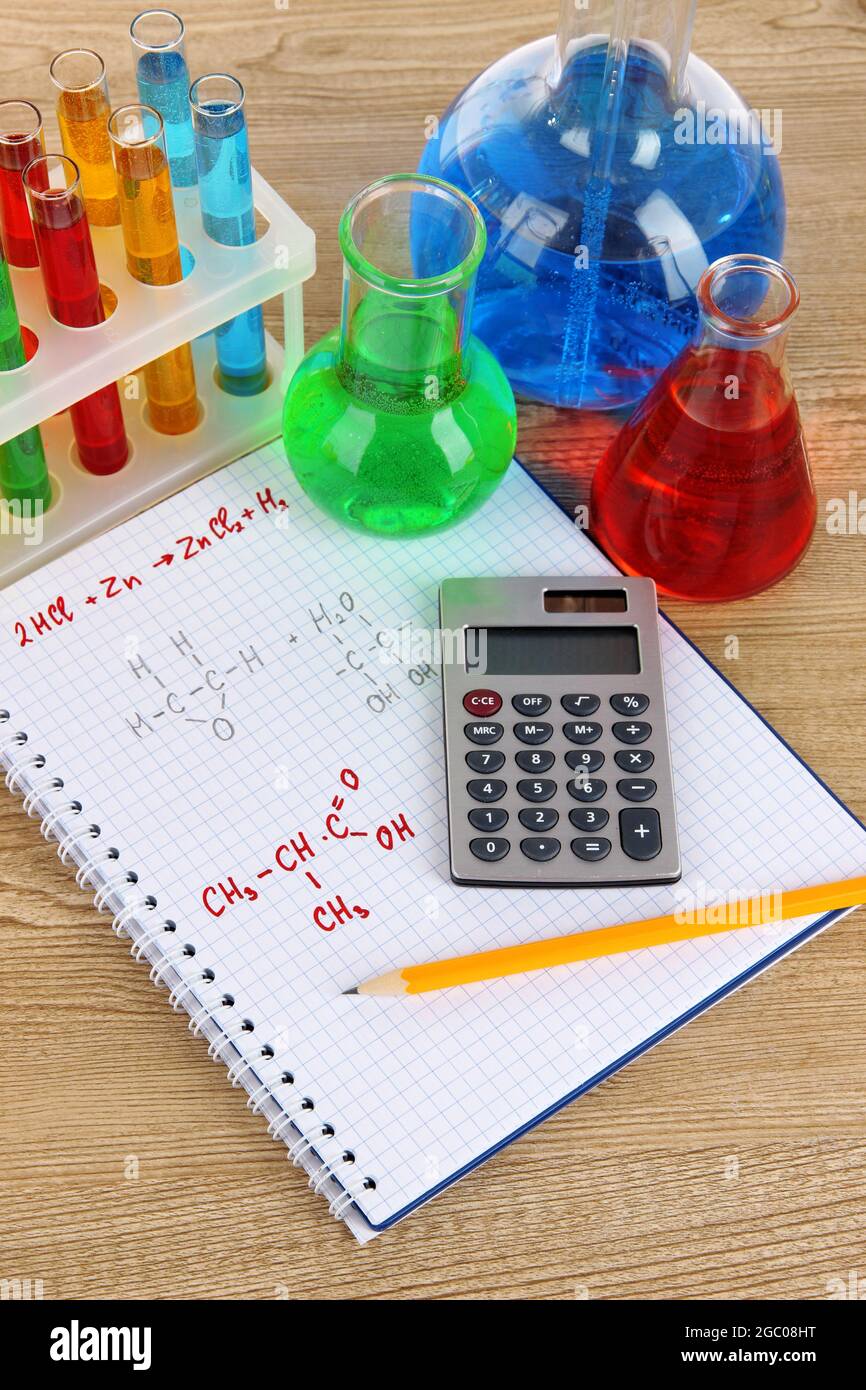 Test tubes with colorful liquids and formulas on table Stock Photo - Alamy