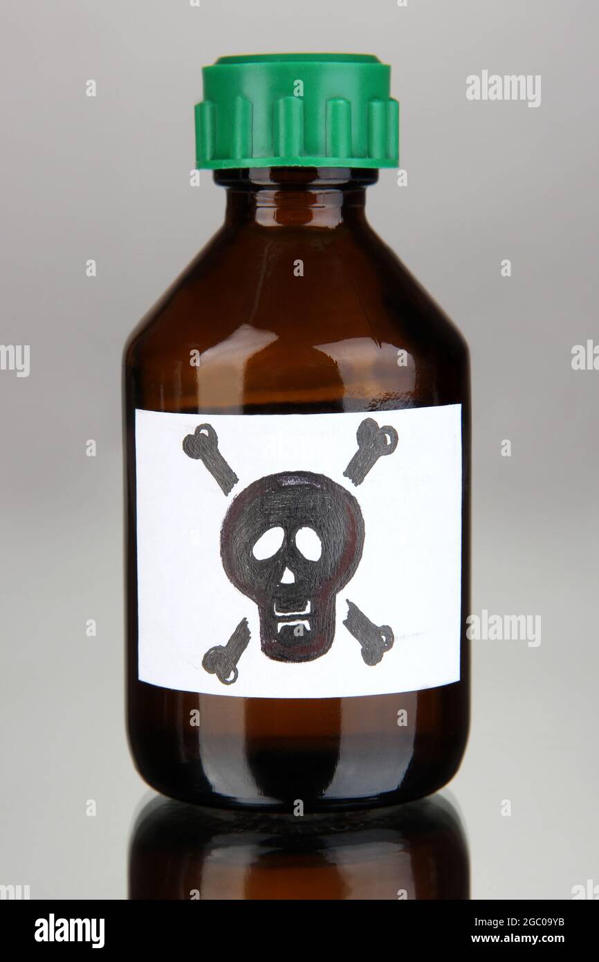Deadly poison in bottle on grey background Stock Photo - Alamy