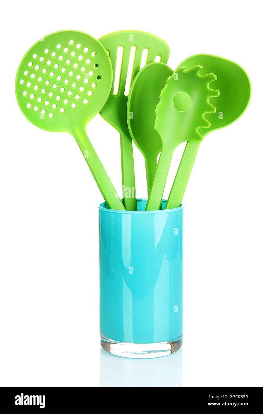 Green plastic kitchen utensil isolated on white Stock Photo - Alamy