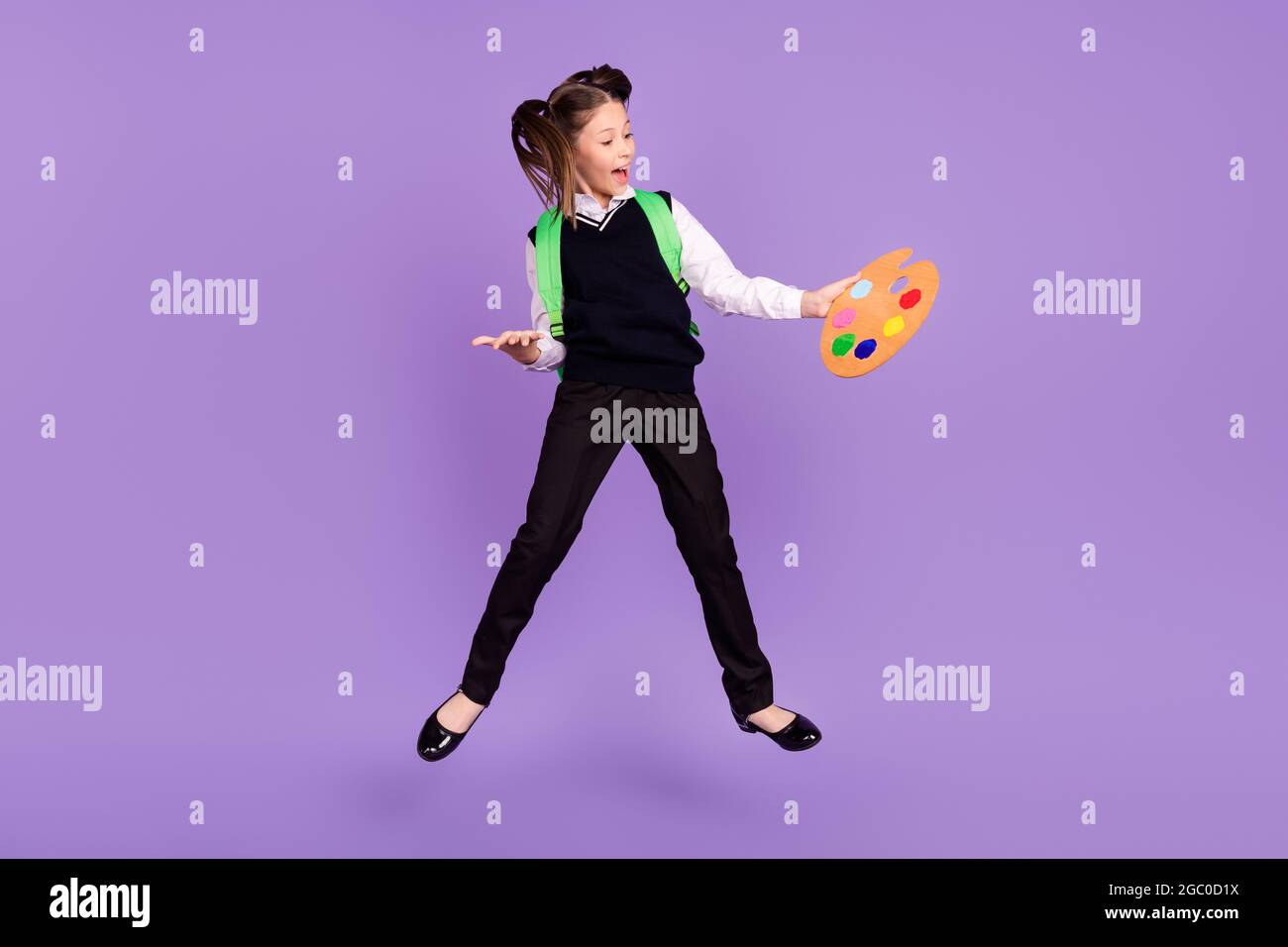 Photo of glad excited painter schoolgirl hold pallet open mouth wear ...