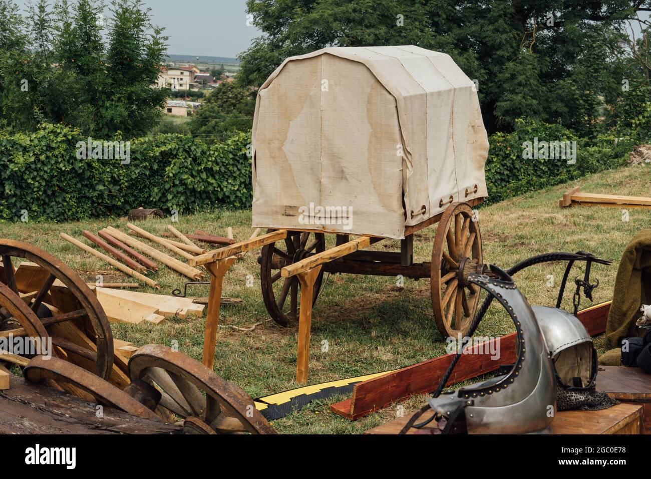 Half-built wooden medieval chariot outside on grass, the construction ...