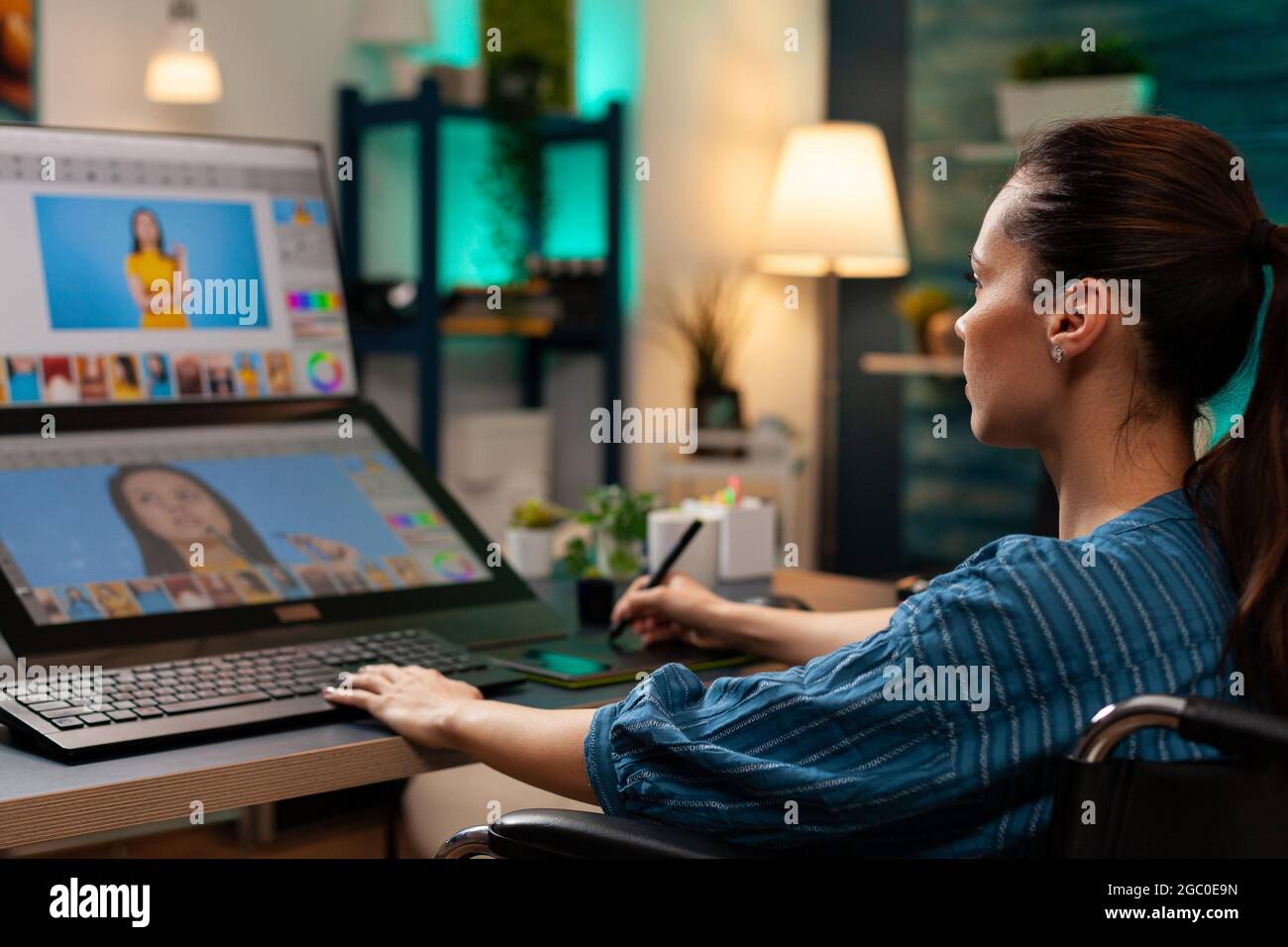 Retouching specialist working on graphic project at studio using modern ...