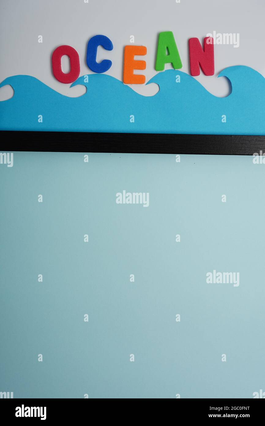 Word ocean written in colored alphabets on a frame with a blue ...