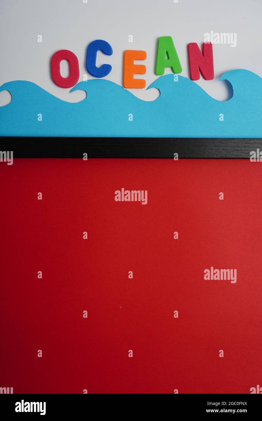 Word oceans written in colored alphabets on a frame with a red ...