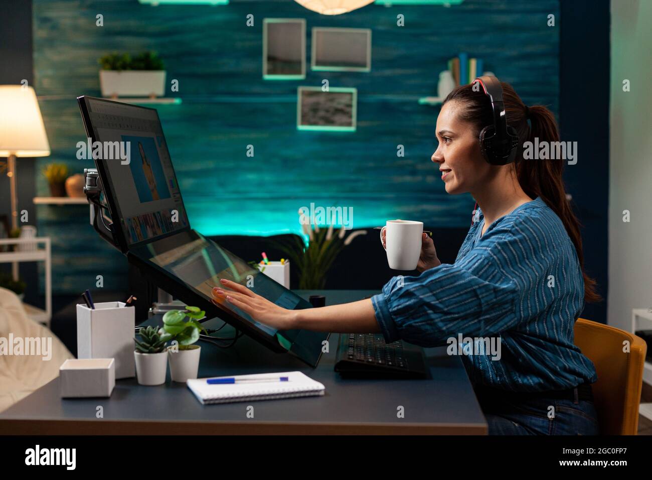 Graphic software editor with headphones working on photography project ...