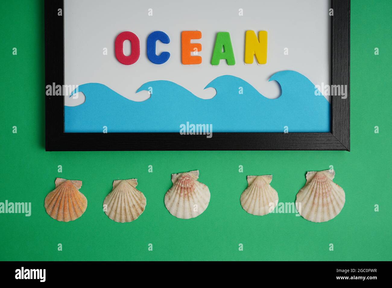 Word ocean written in colored alphabets on a frame with a green ...