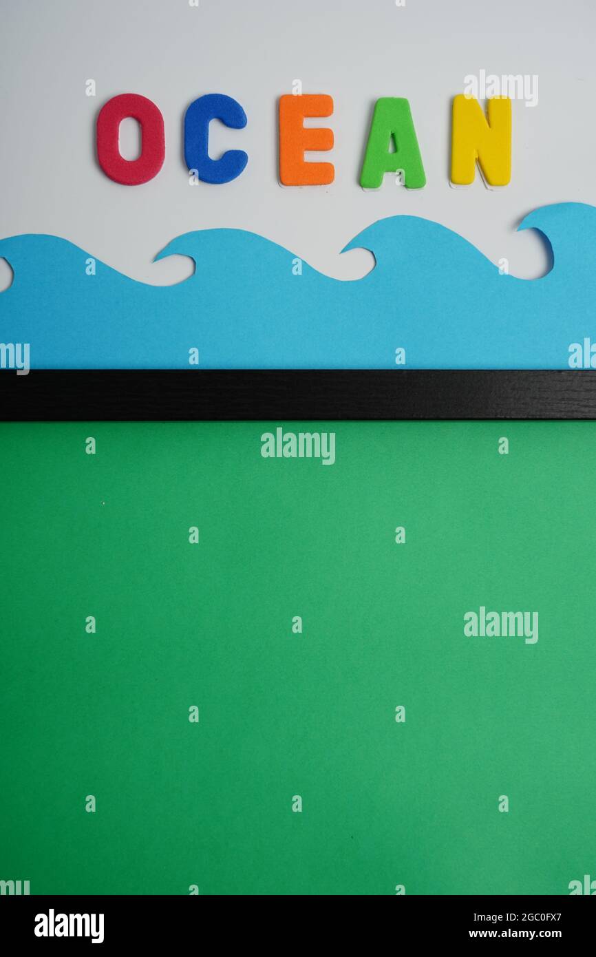 Word ocean written in colored alphabets on a frame with a green ...