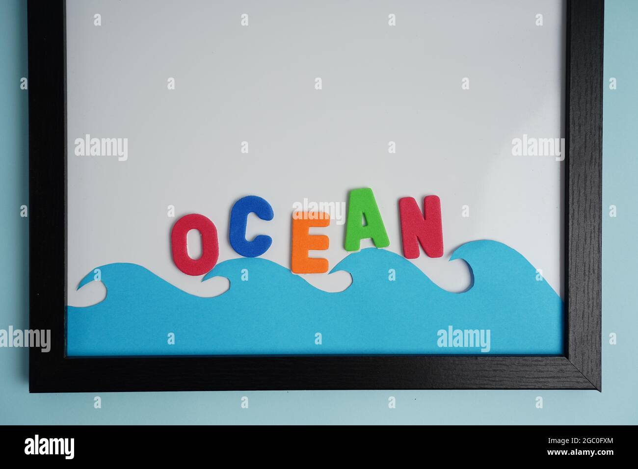 Word ocean written in colored alphabets on a frame with a blue ...