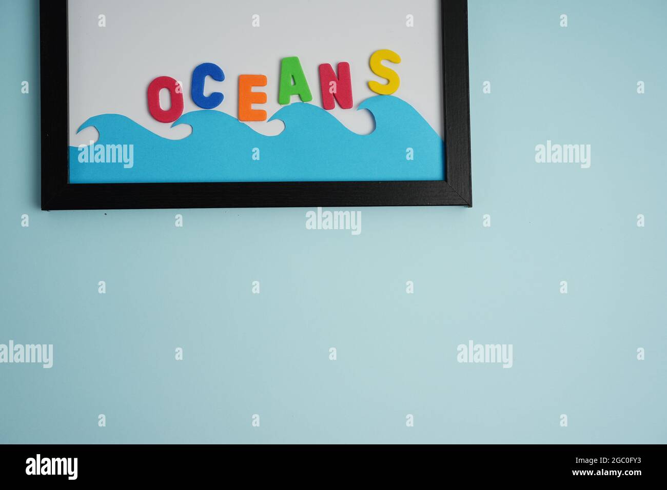 Word ocean written in colored alphabets on a frame with a blue ...