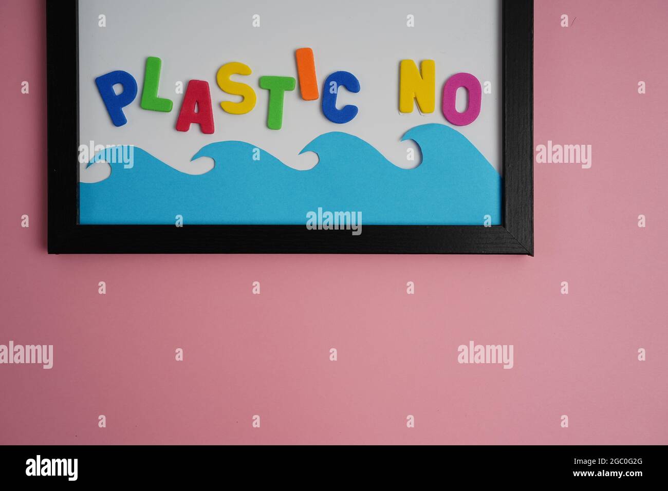 Word plastic written in colored alphabets on a frame with a pink ...