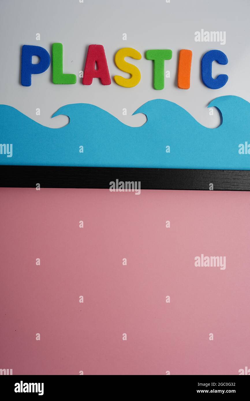 Word plastic written in colored alphabets on a frame with a pink ...