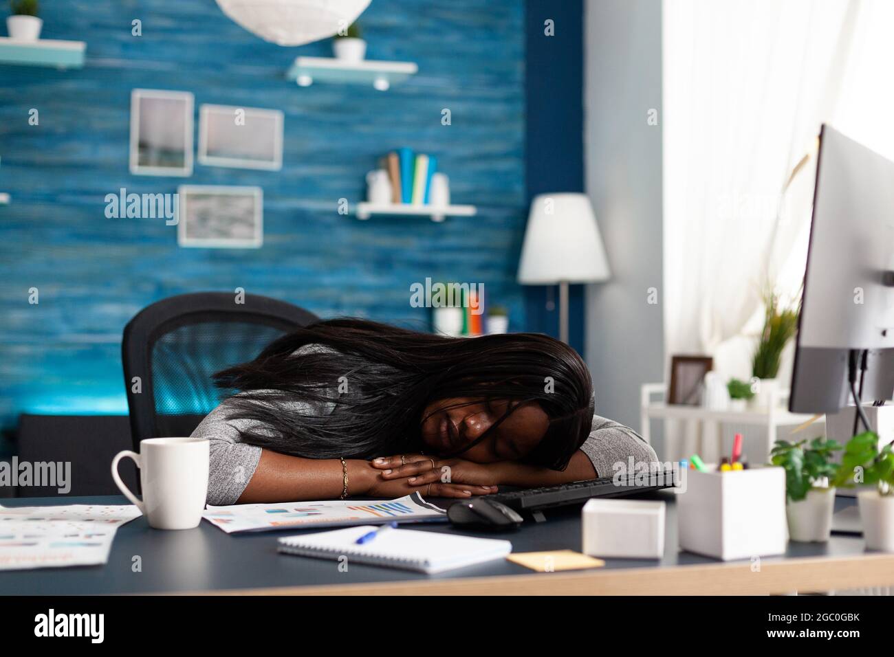 Exhausted tired workaholic black student sleeping on desk table in ...