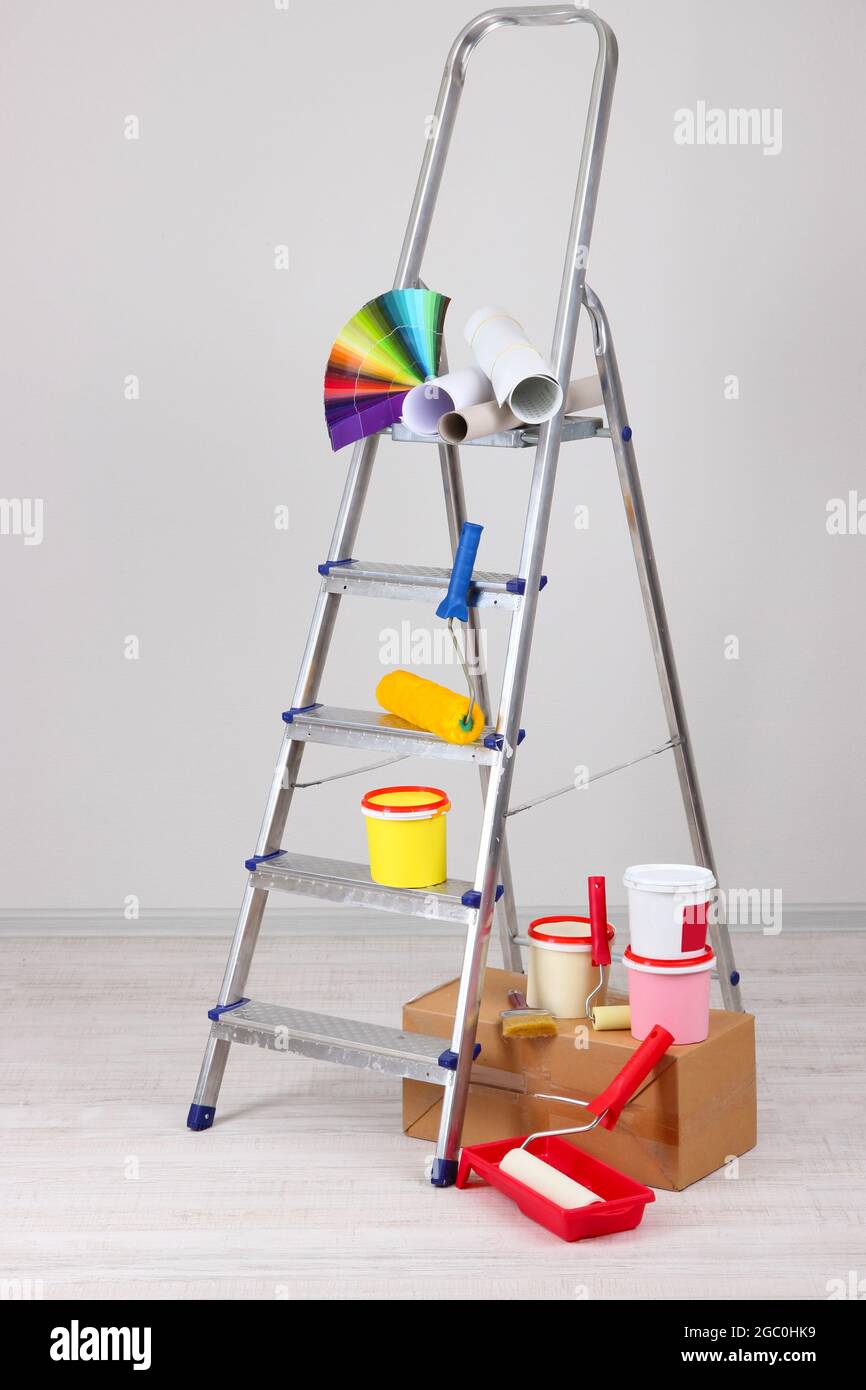 Metal ladder and paint in room Stock Photo - Alamy