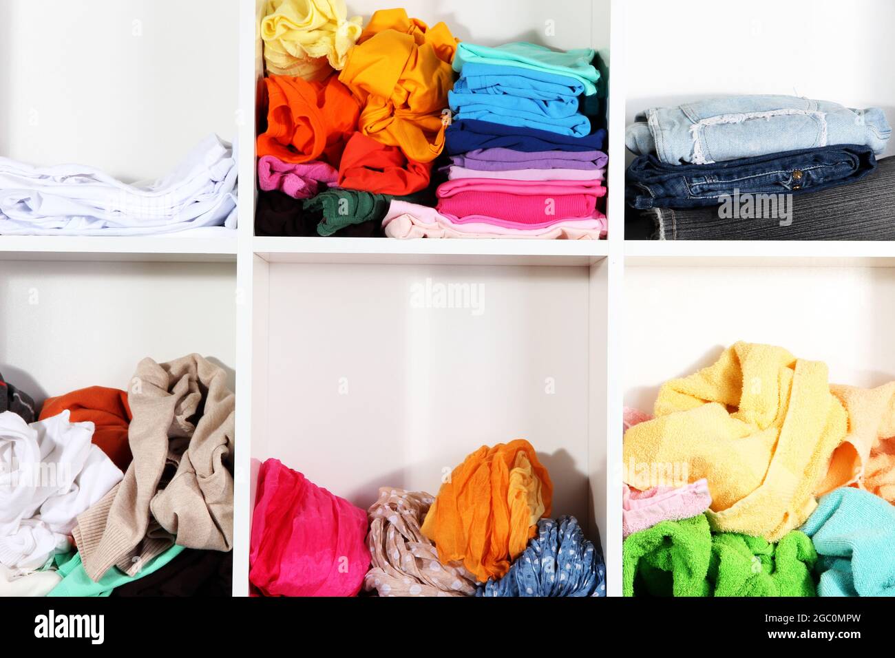 Clothing scattered on shelves Stock Photo - Alamy