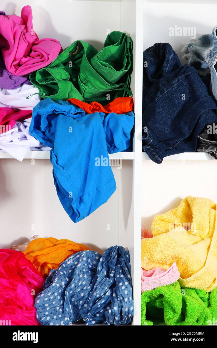 Clothing scattered on shelves Stock Photo - Alamy