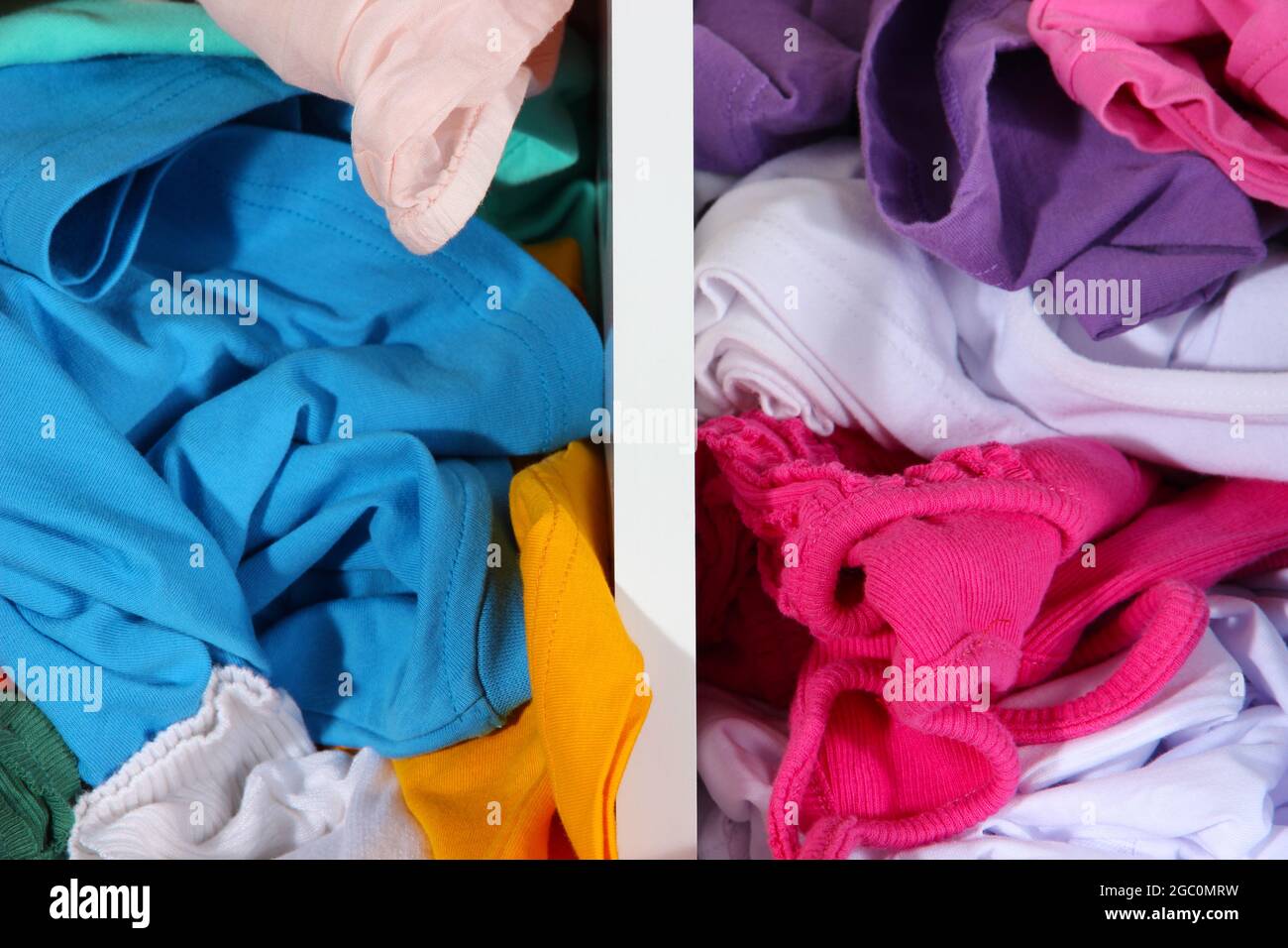 Clothing scattered on shelves Stock Photo - Alamy