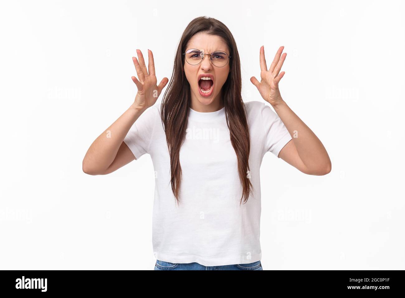 Waist-up portrait of angry, pissed-off brunette pretty girl in glasses ...