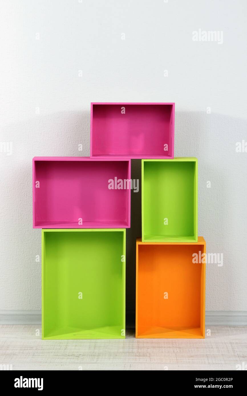 Beautiful colorful crates as shelves standing in room Stock Photo - Alamy