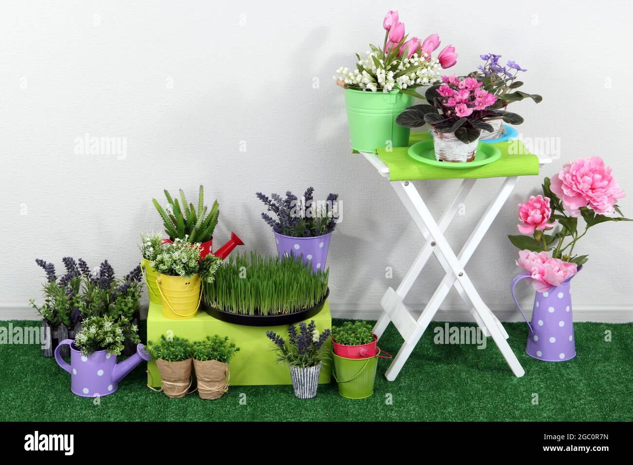 Color crate and table with decorative elements and flowers standing on ...