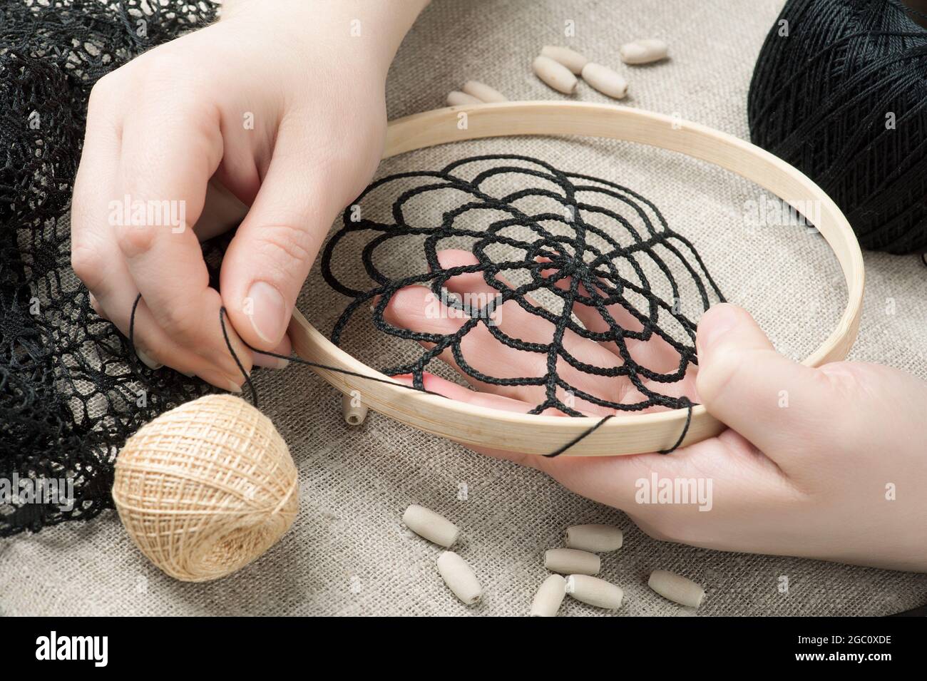 Closeup of female hands holding thread. Handmade workshop composition ...