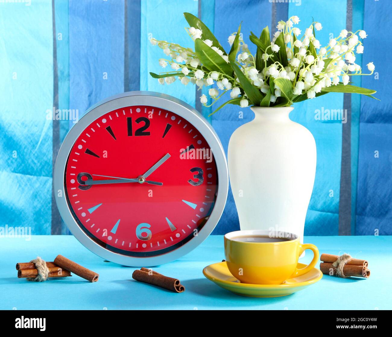 Cup coffee and clock on bright background Stock Photo - Alamy