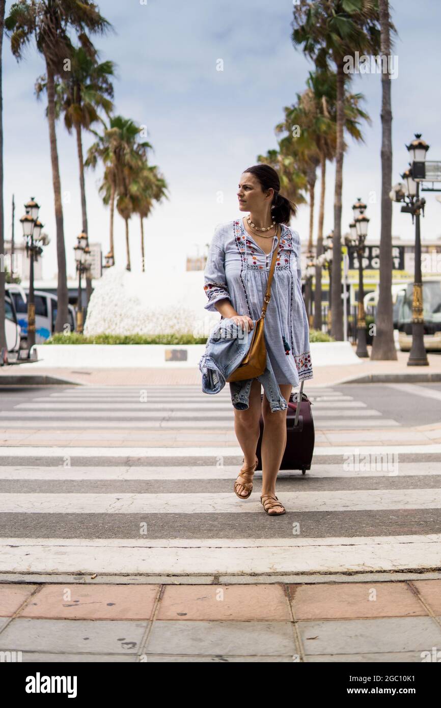 Beautiful Caucasian woman crossing the zebra crossing to enter t Stock ...