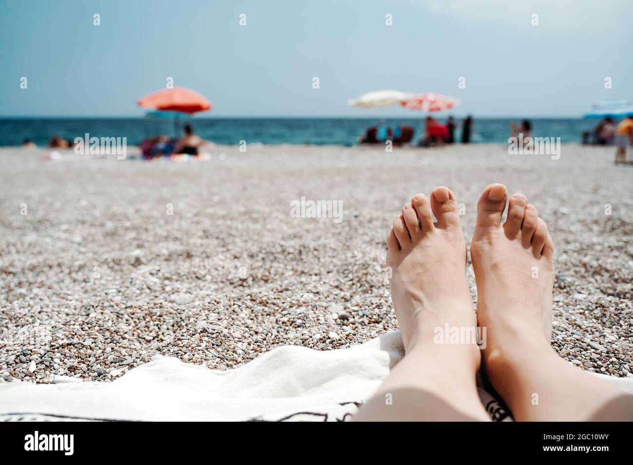 Sunbathing And Relaxing Girl On The Sea Beach Female Feet And Legs On