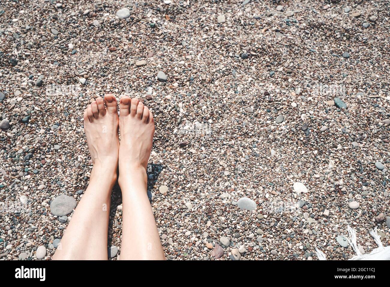 Sunbathing And Relaxing Girl On The Sea Beach Female Feet And Legs On