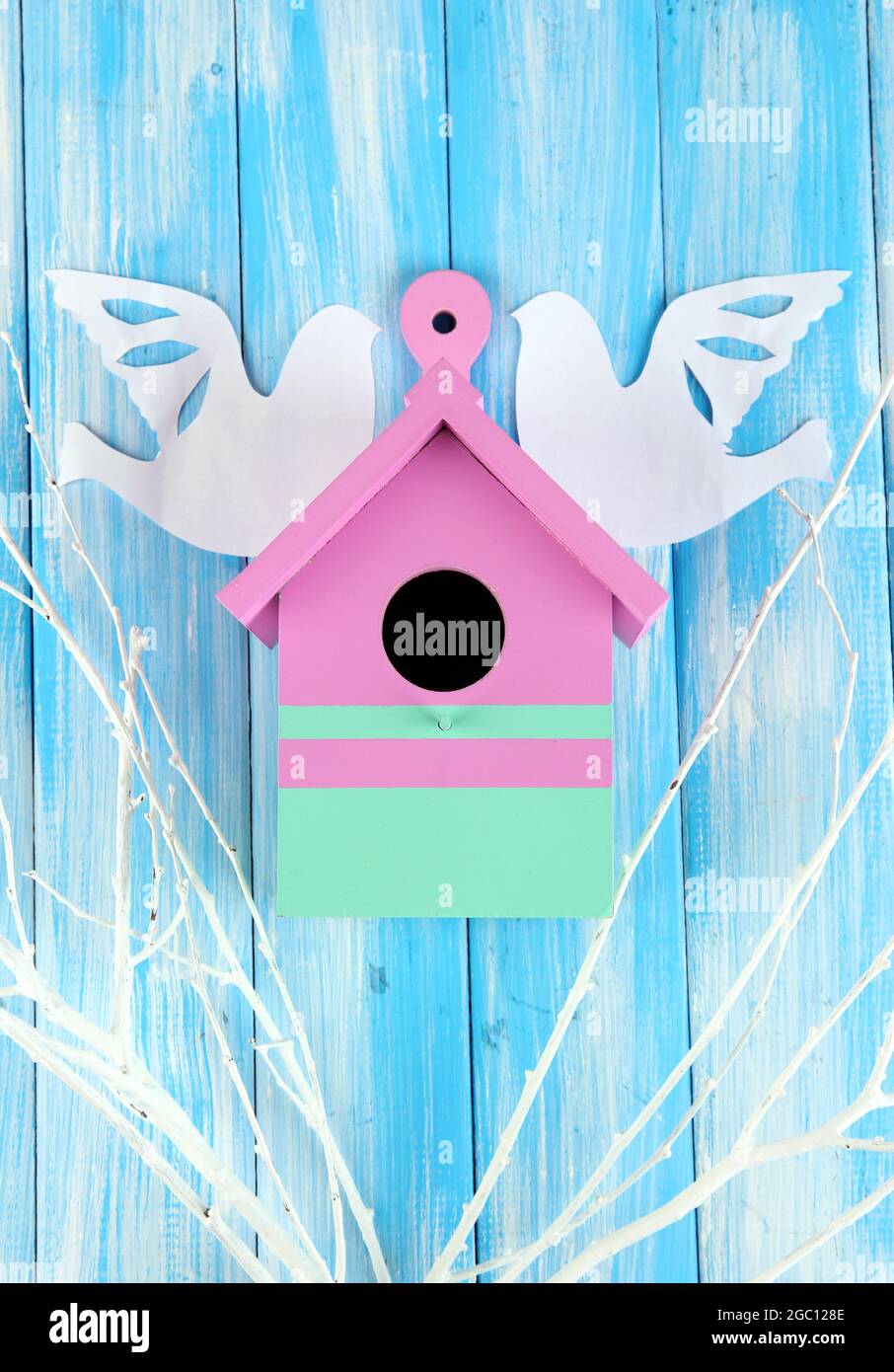 Decorative nesting box with paper birds and color branches, on color ...