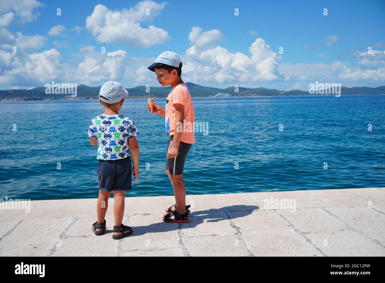 ZADAR, CROATIA - Jul 08, 2021: The two boys eating ice cream by the ...